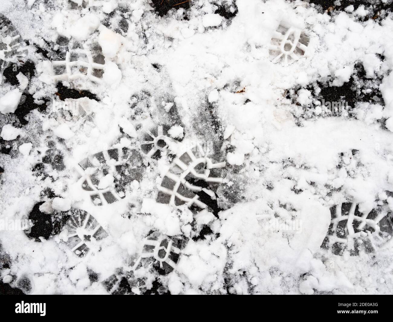 above view of textured footprints in the first snow on surface of ...