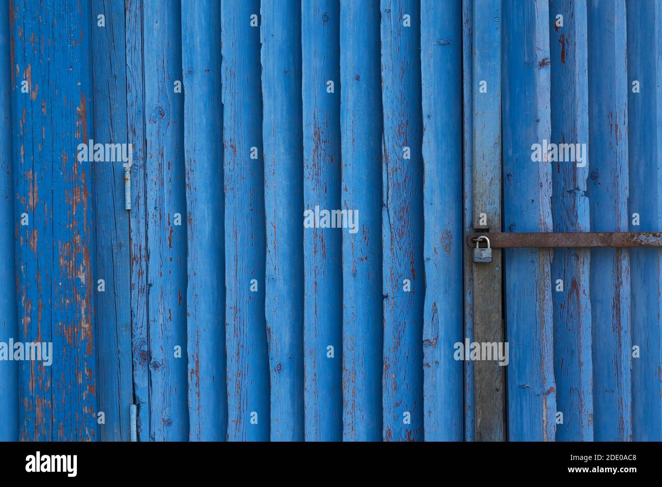 Blue painted wood plank door on facade of storage shed Stock Photo - Alamy