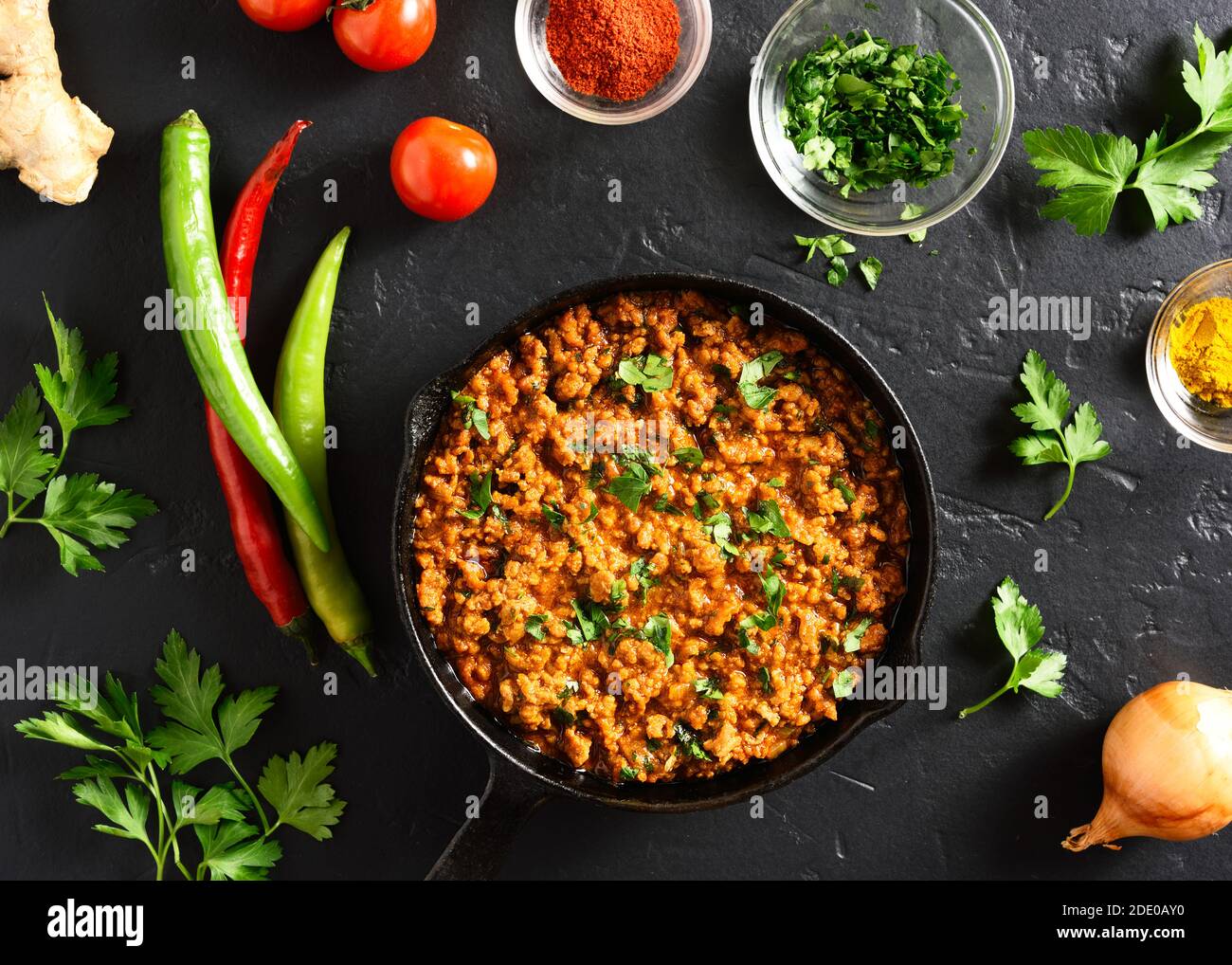 Keema curry in frying pan over black stone background. Indian and ...
