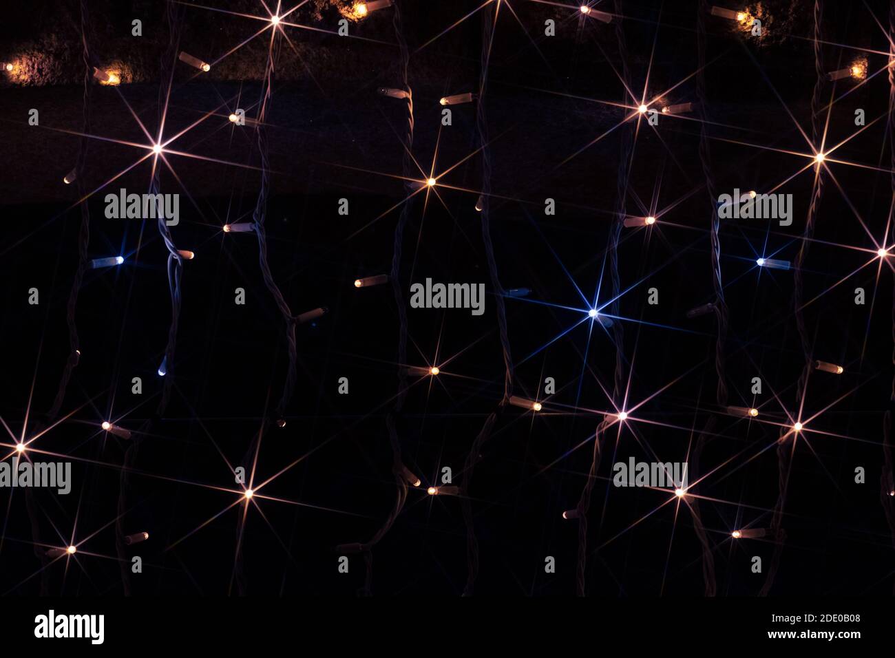 Christmas lights with starburst effect at night Stock Photo - Alamy
