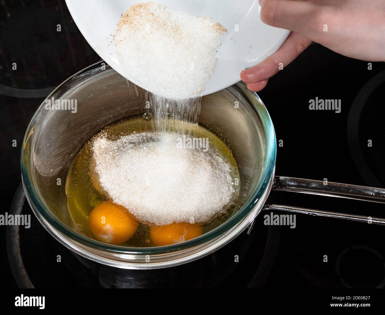cooking sweet sponge cake at home - adding sugar with cinnamon to raw ...