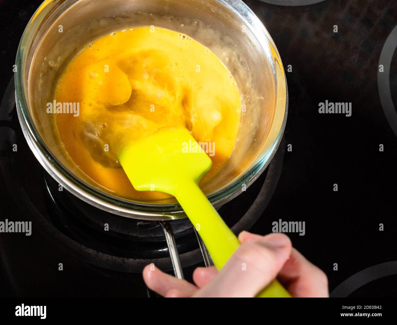 cooking sweet sponge cake at home - above view of stirring mixture of ...