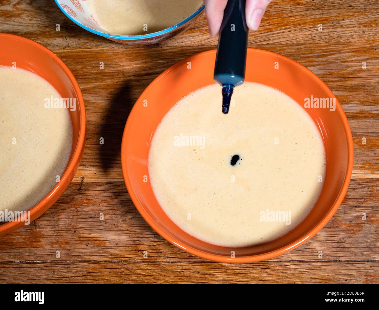 cooking sweet sponge cake at home - top view of dripping drop of blue ...