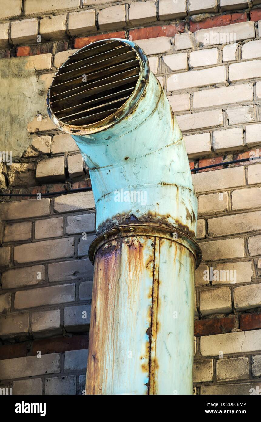 Old and rusty external outlet point of forced-type ventilation duct ...