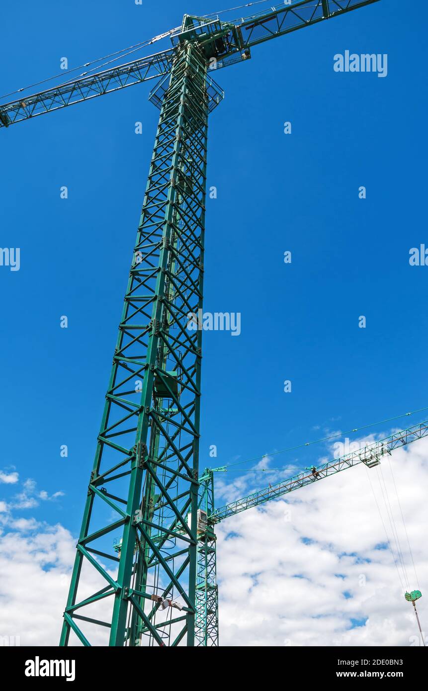 View on two high construction cranes at stage of erection of the ...