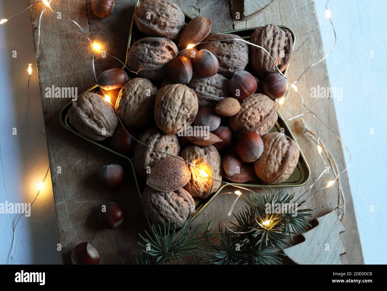 Dry fruits in shell. Christmas light Stock Photo - Alamy