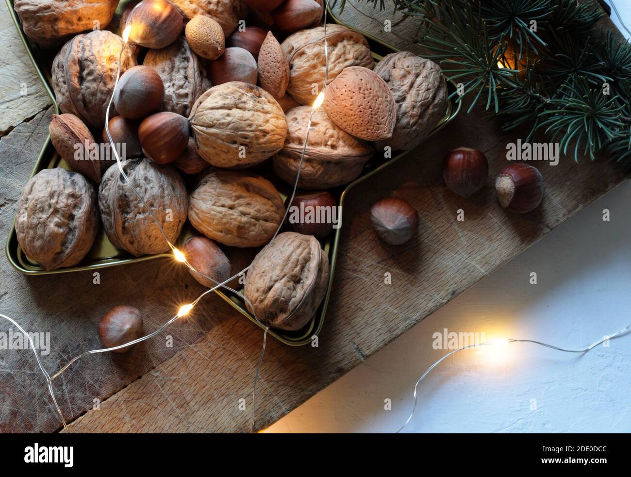 Dry fruits in shell. Christmas light Stock Photo - Alamy