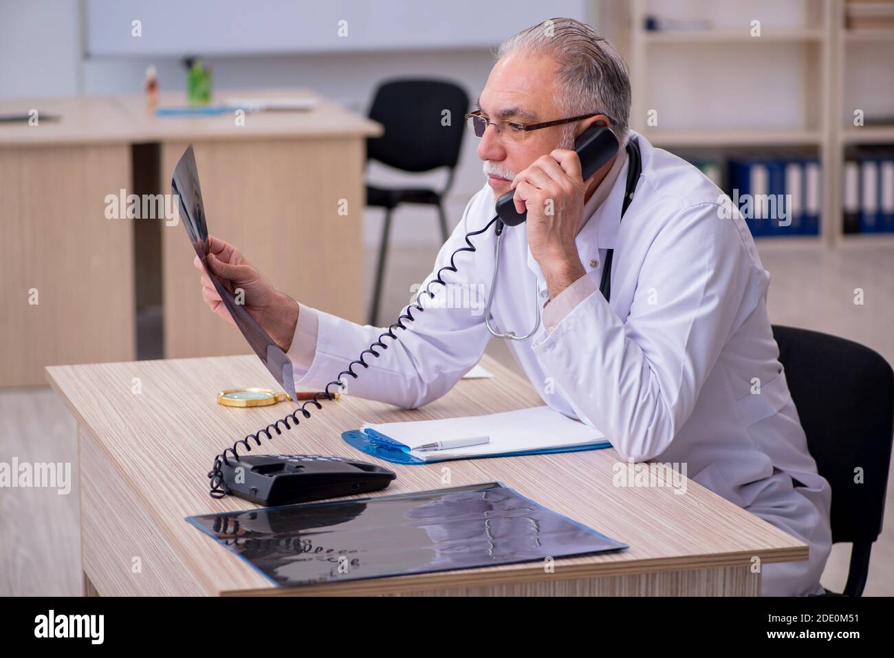 Old doctor radiologist working in the clinic Stock Photo - Alamy