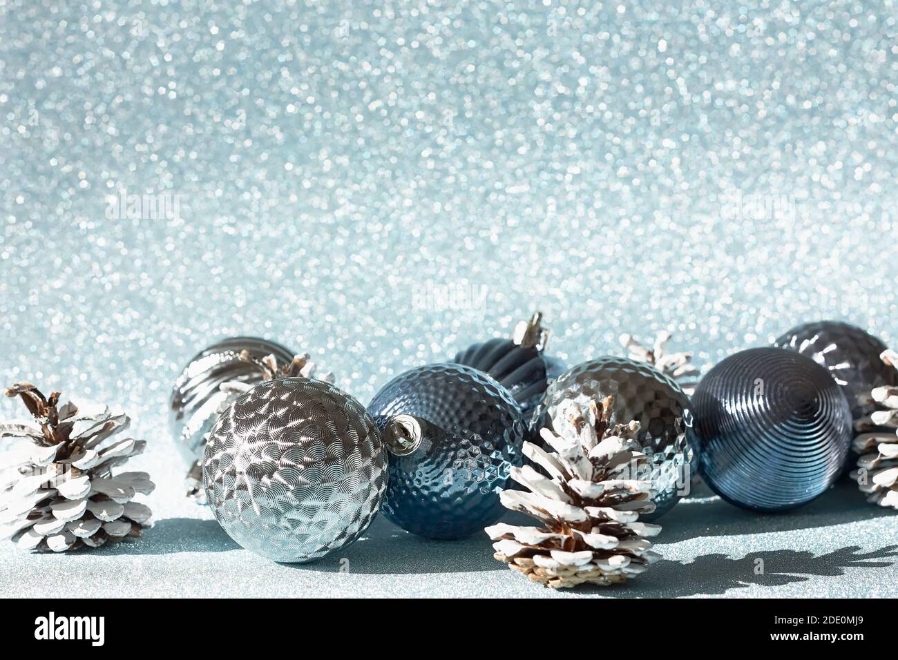 Christmas composition in blue with christmas balls and pine cones on ...