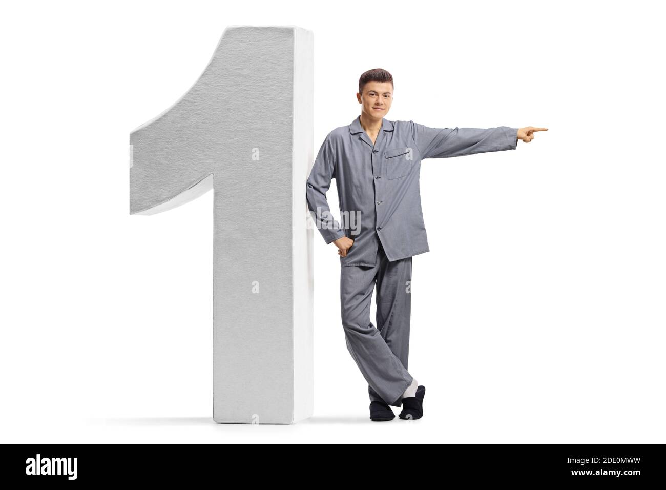 Full length portrait of a guy in pajamas leaning on number one and ...