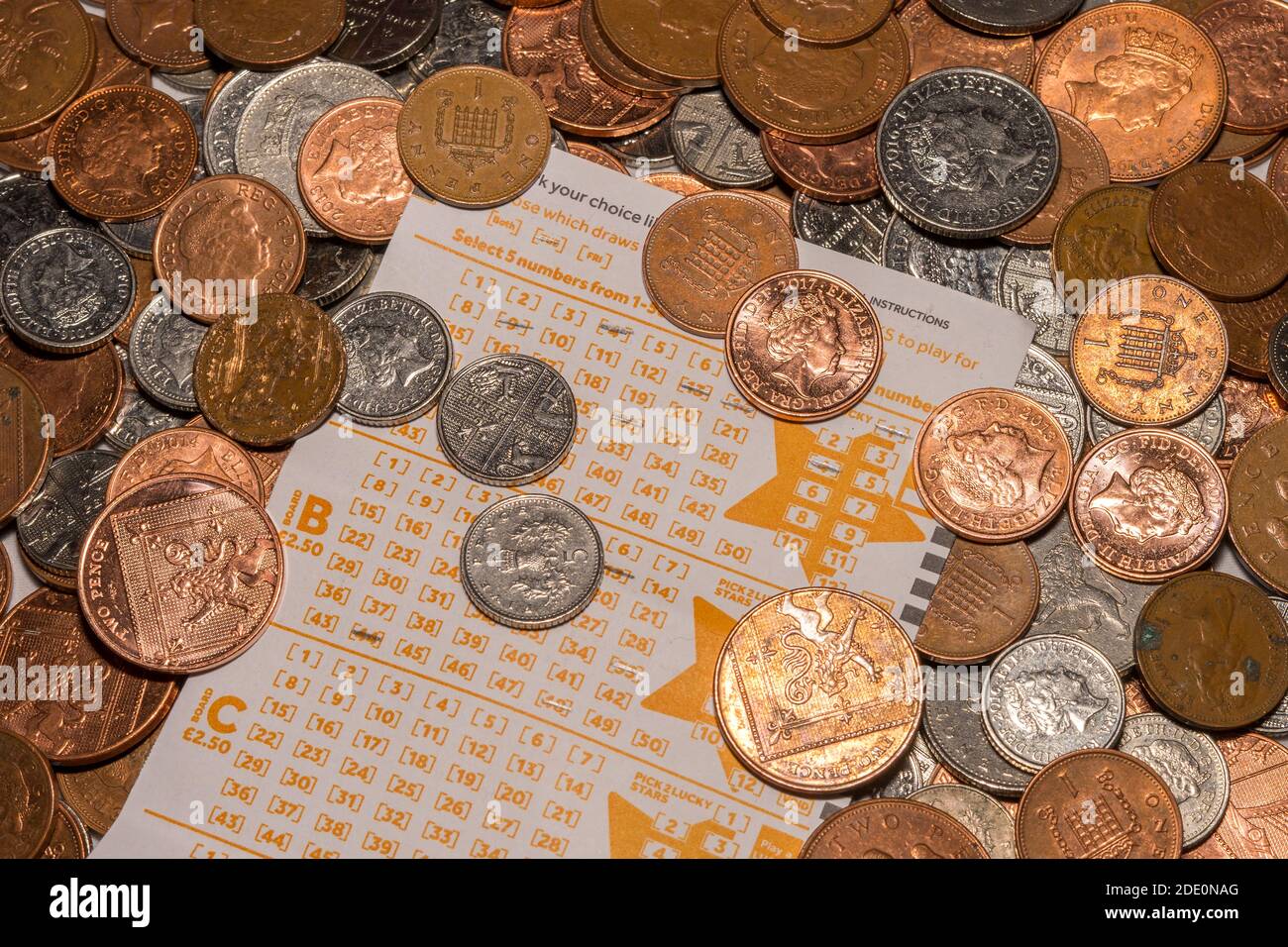 UK Euromillions Lottery selection slip surrounded by small denomination ...