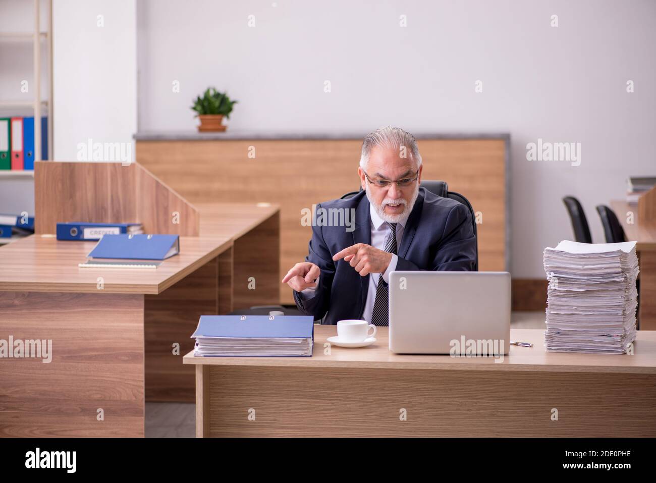 Old employee working in the office Stock Photo - Alamy