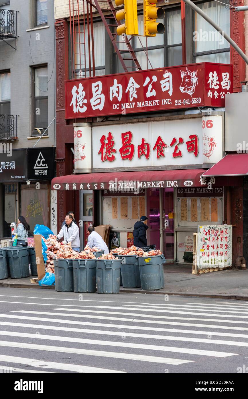 chinese signs above DC meat market inc store butchers with butchering ...