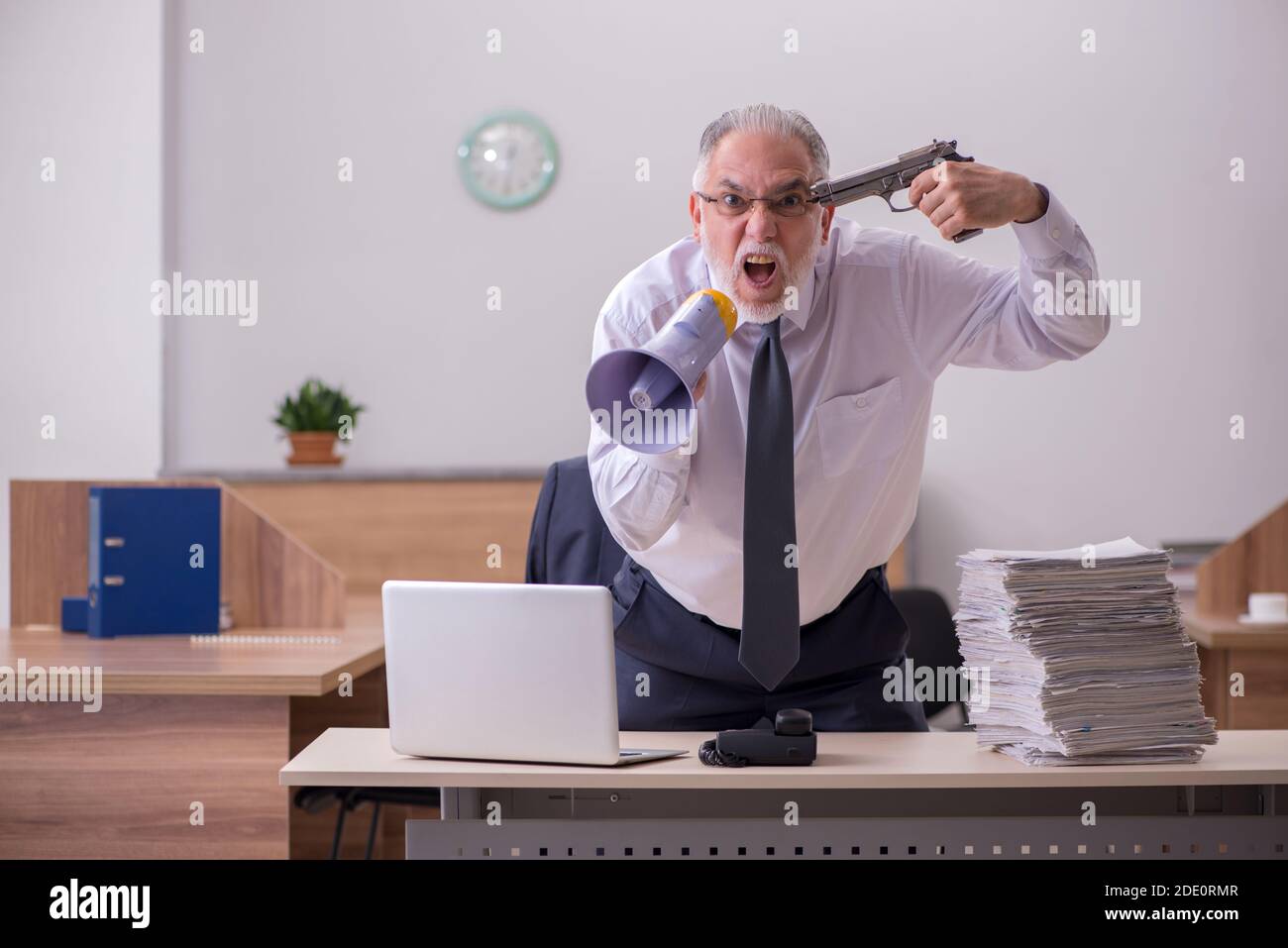 Old employee being desperate with excessive work in the office Stock ...
