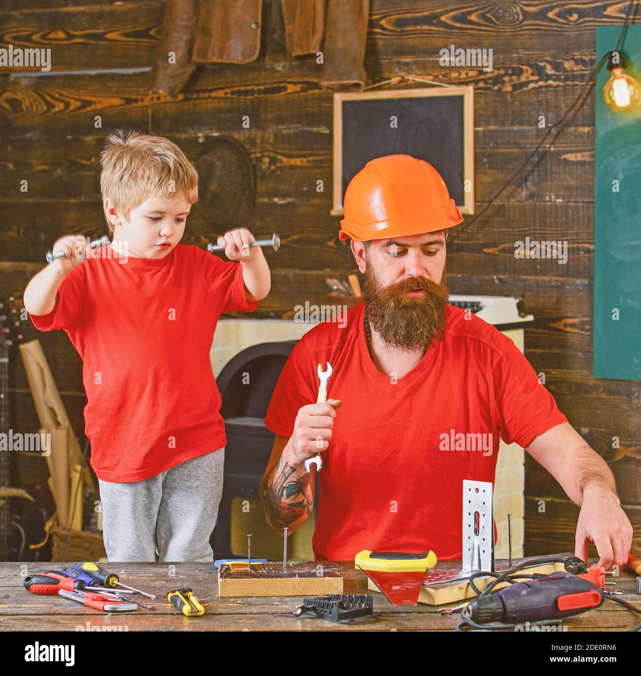 Boy, child cheerful holds bolts or screws, having fun while ...