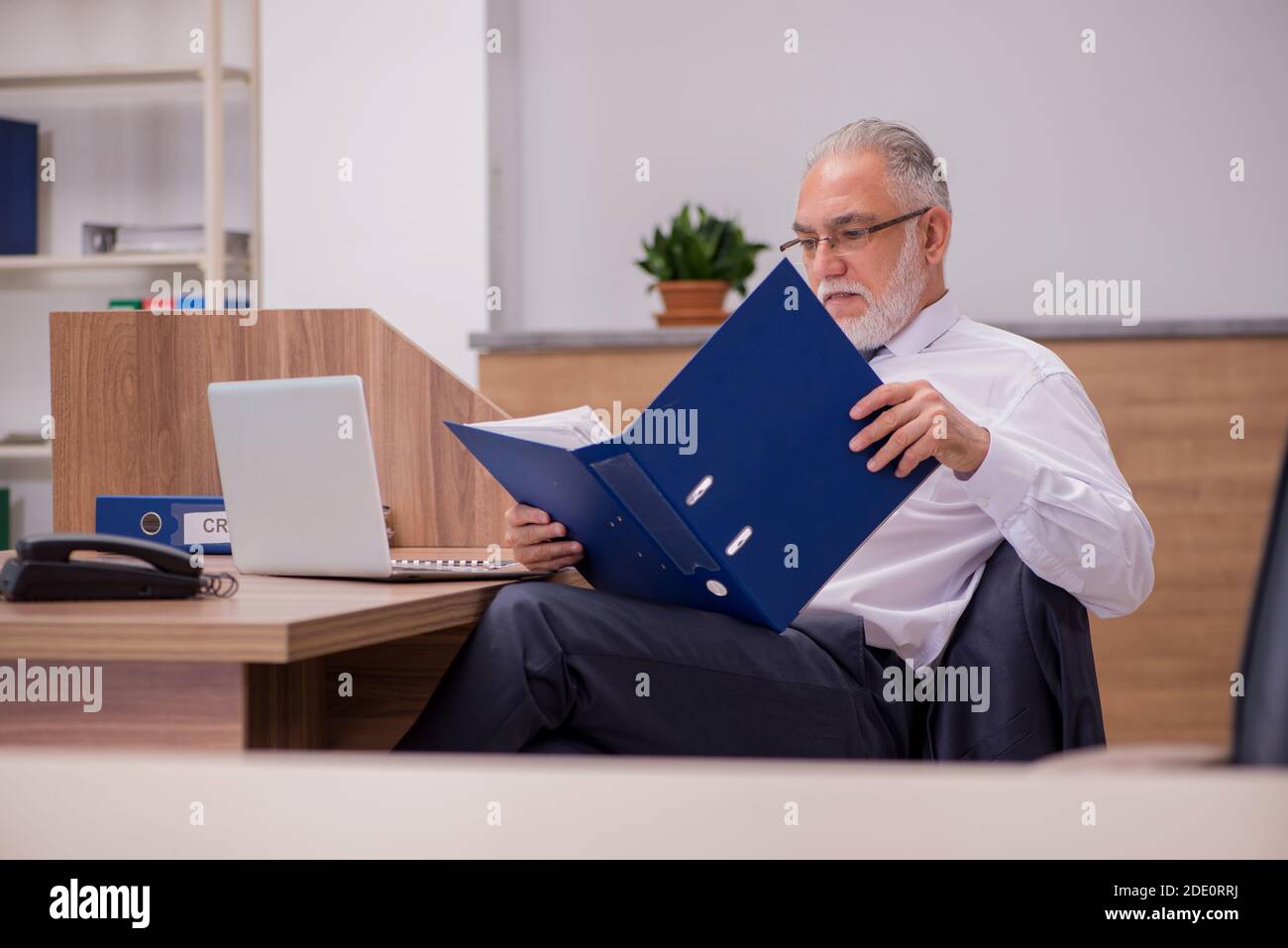 Old employee working in the office Stock Photo - Alamy