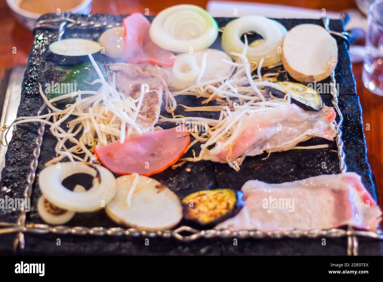 Grilling meat and veggies or yakiniku at a local restaurant in Aichi ...