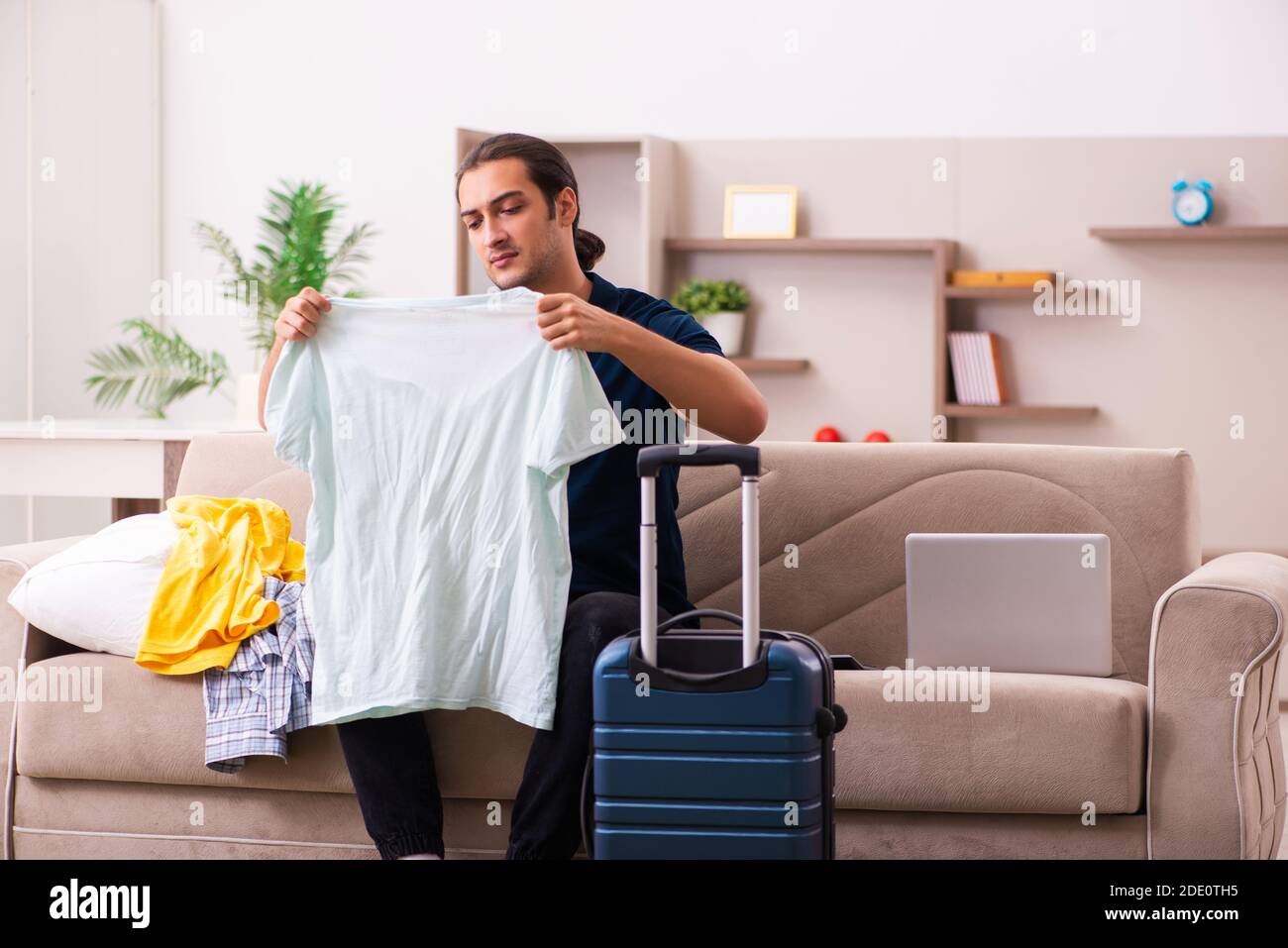 Young man preparing for trip at home Stock Photo - Alamy