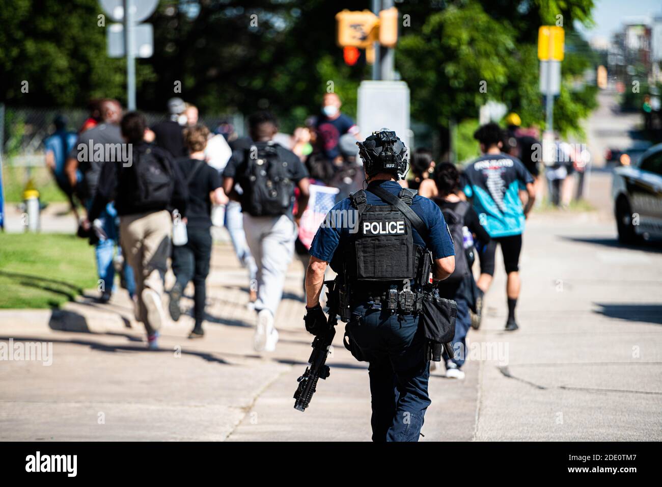 Police Officer Chases Protesters Stock Photo - Alamy