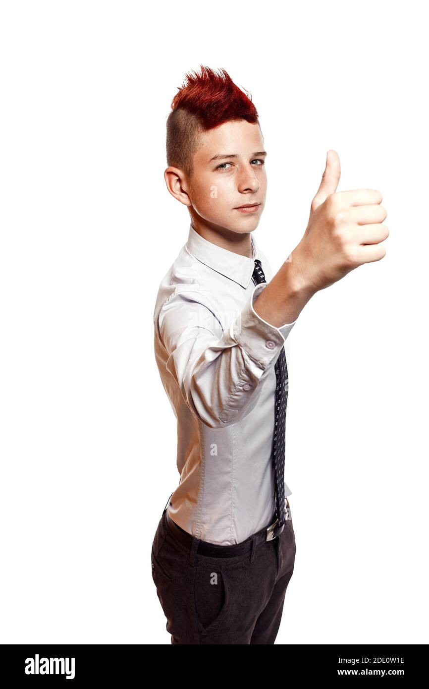 A smiling teenager with red mohawk wearing shirt and tie shows his ...