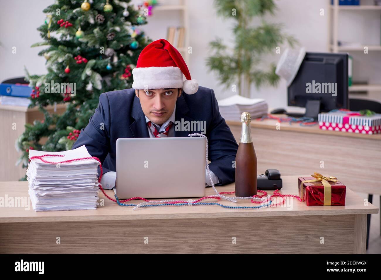 Young employee celebrating new year in the office Stock Photo - Alamy