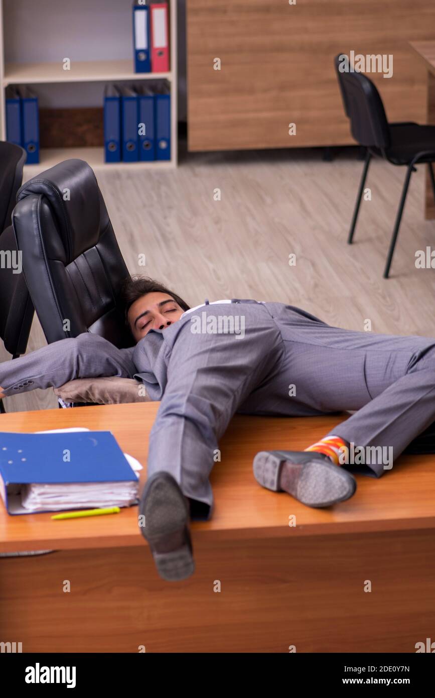 Young employee sleeping at workplace Stock Photo - Alamy