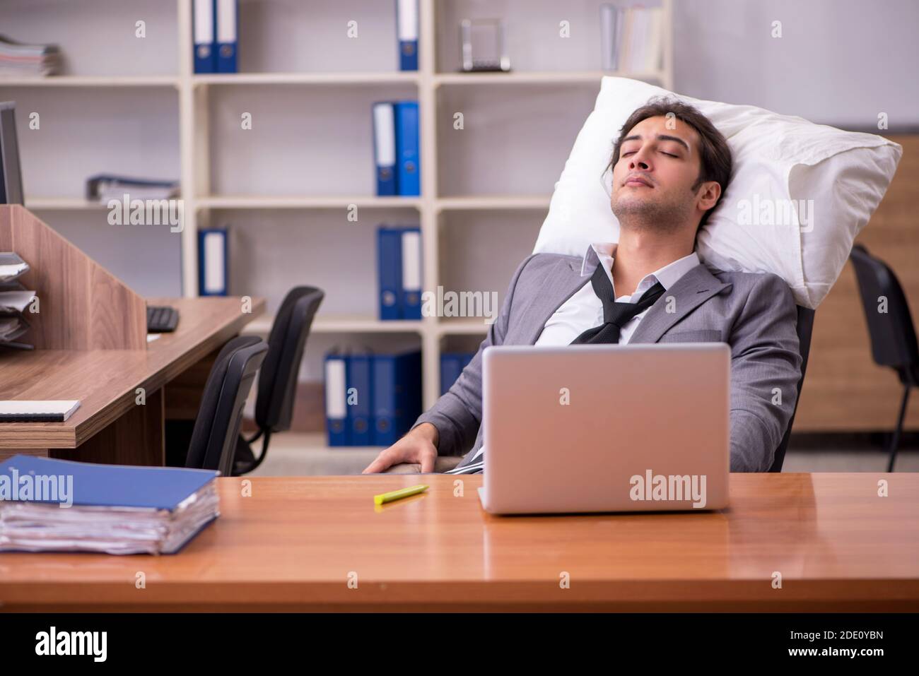 Young employee sleeping at workplace Stock Photo - Alamy