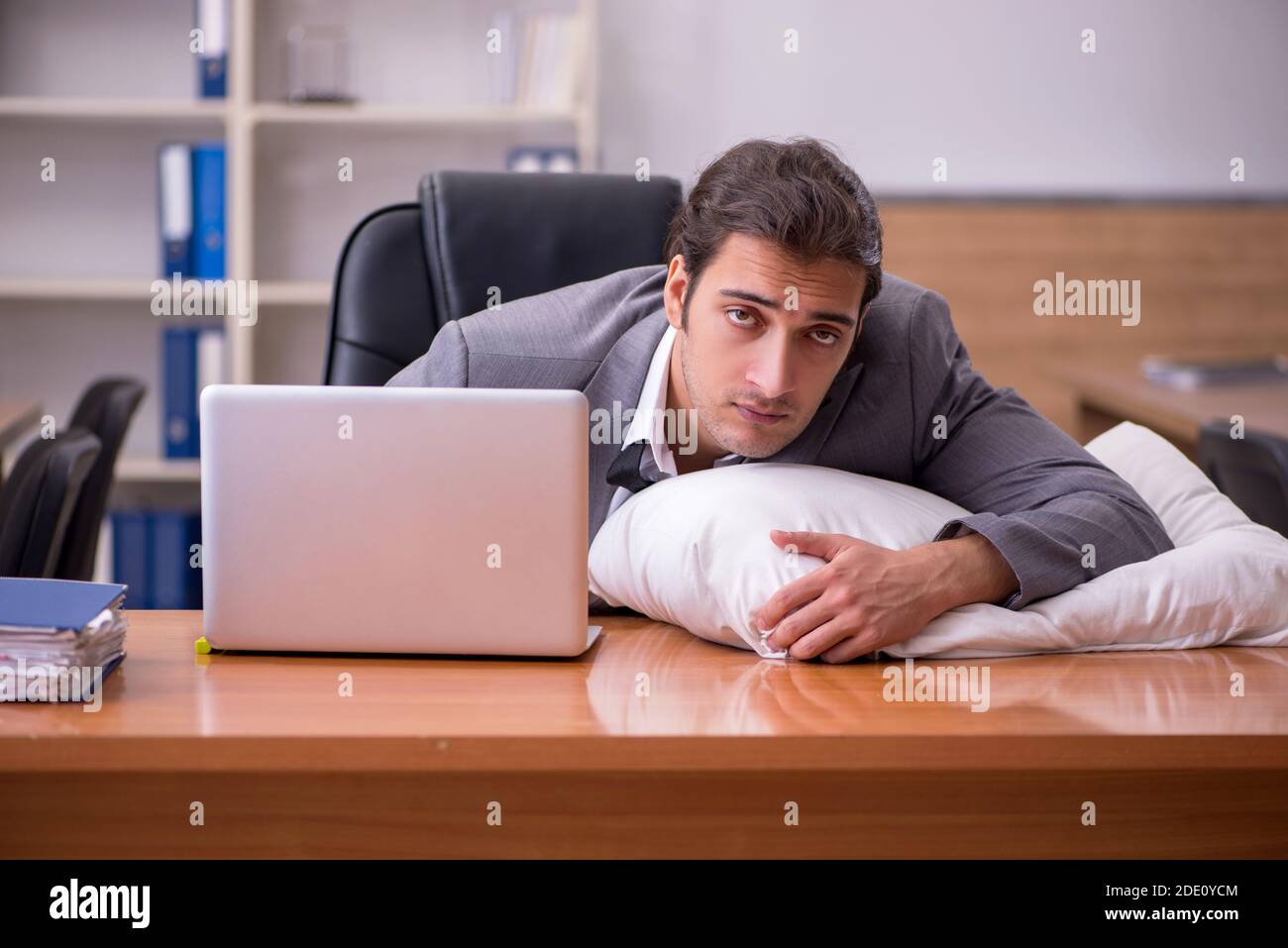 Young employee sleeping at workplace Stock Photo - Alamy