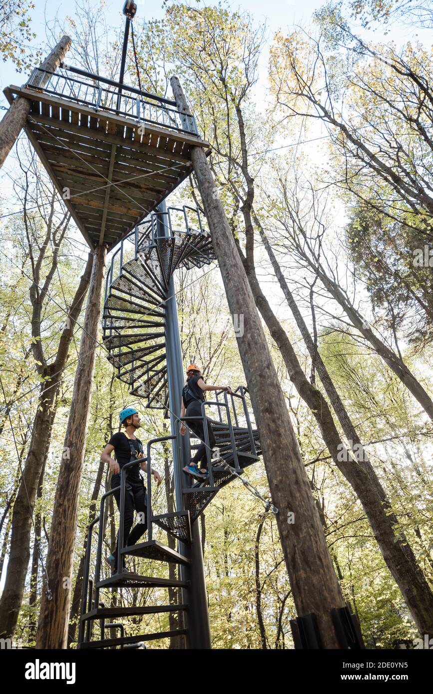 Rope Jumping tower with spiral staircase and people climbing up Stock ...