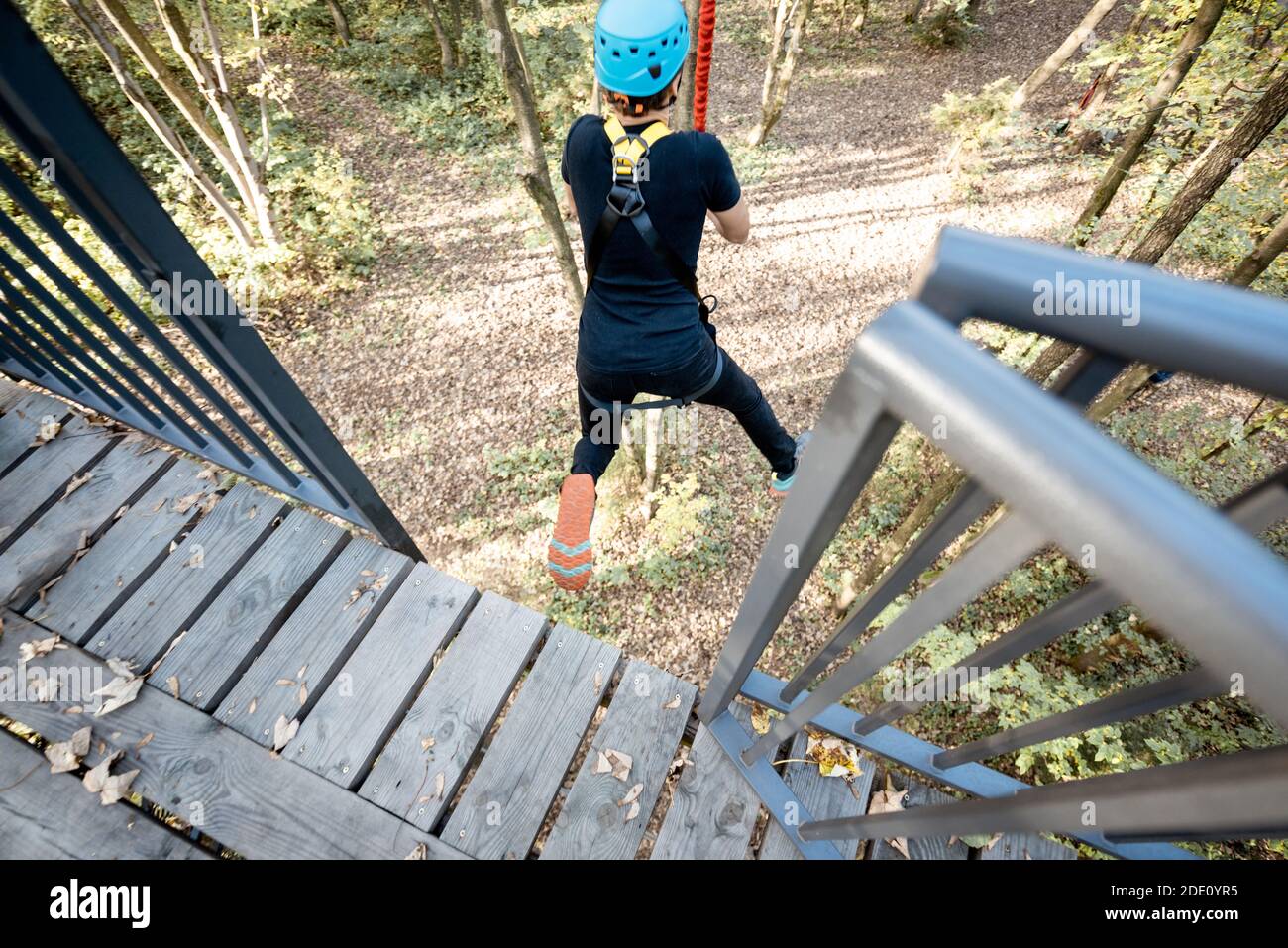 Man jumping from a bungee tower, having an active recreation in a rope ...