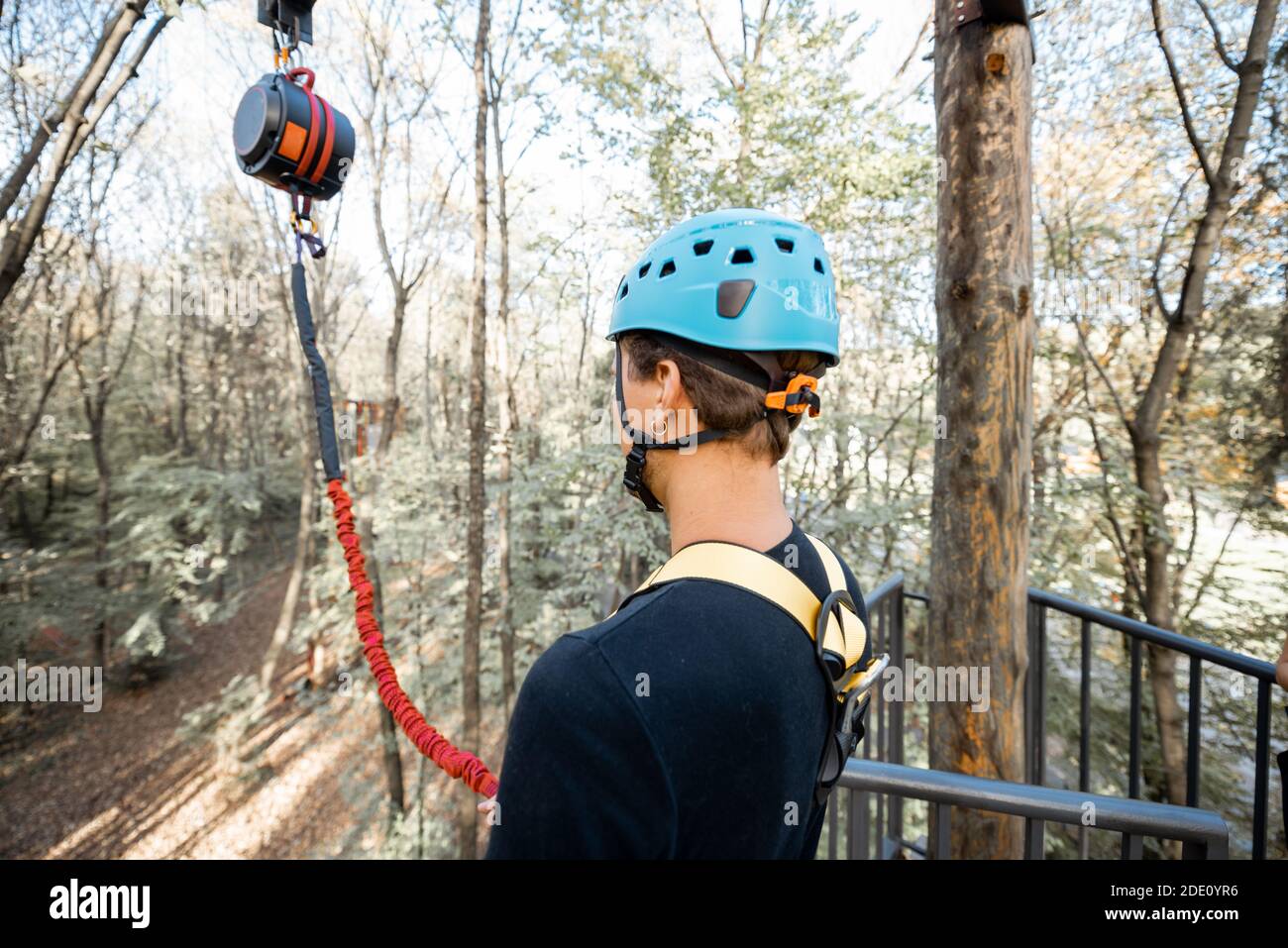Man preparing for a bungee jump stnading on the top of a tower in the ...