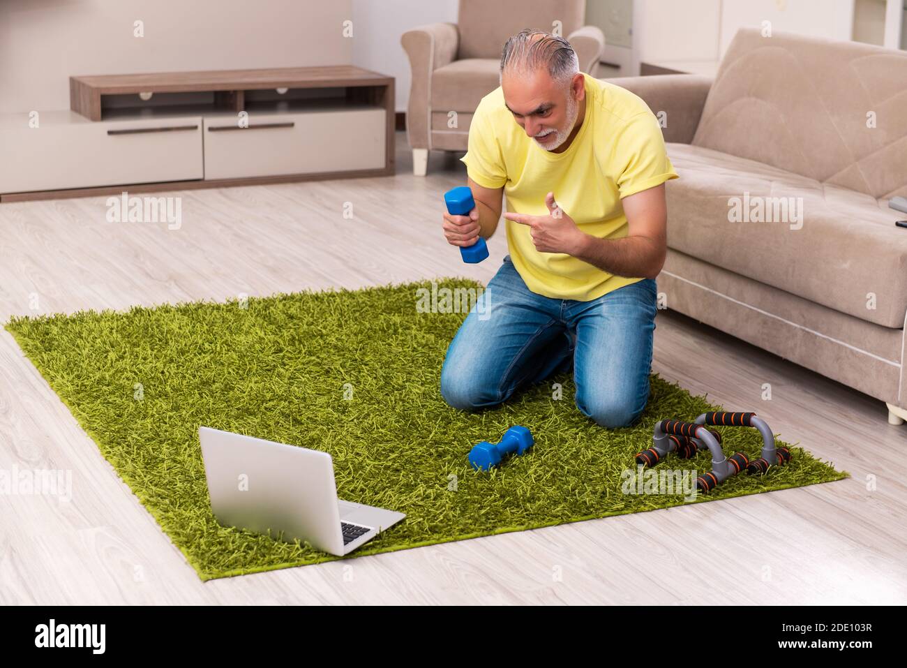Old man doing sport exercises at home Stock Photo - Alamy