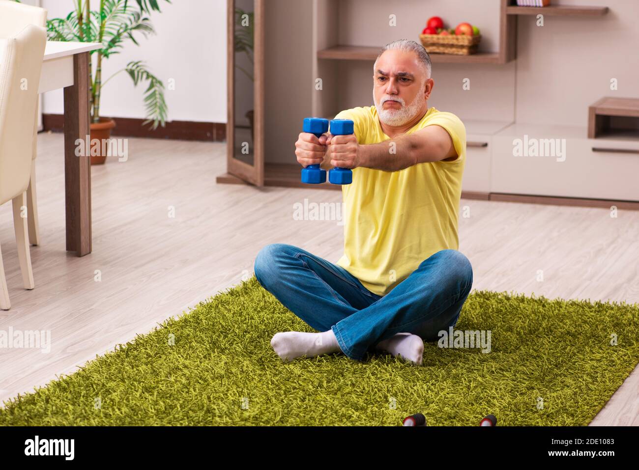 Old man doing sport exercises at home Stock Photo - Alamy