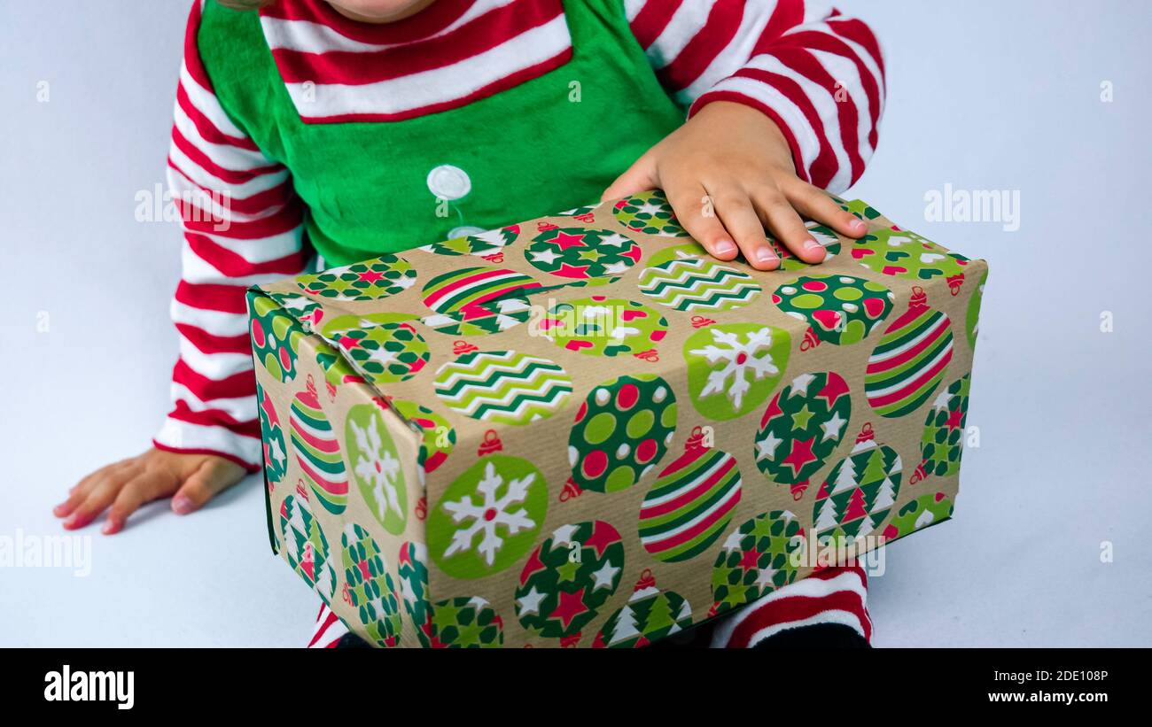Little elf with a cute smile is sitting on the white background and ...
