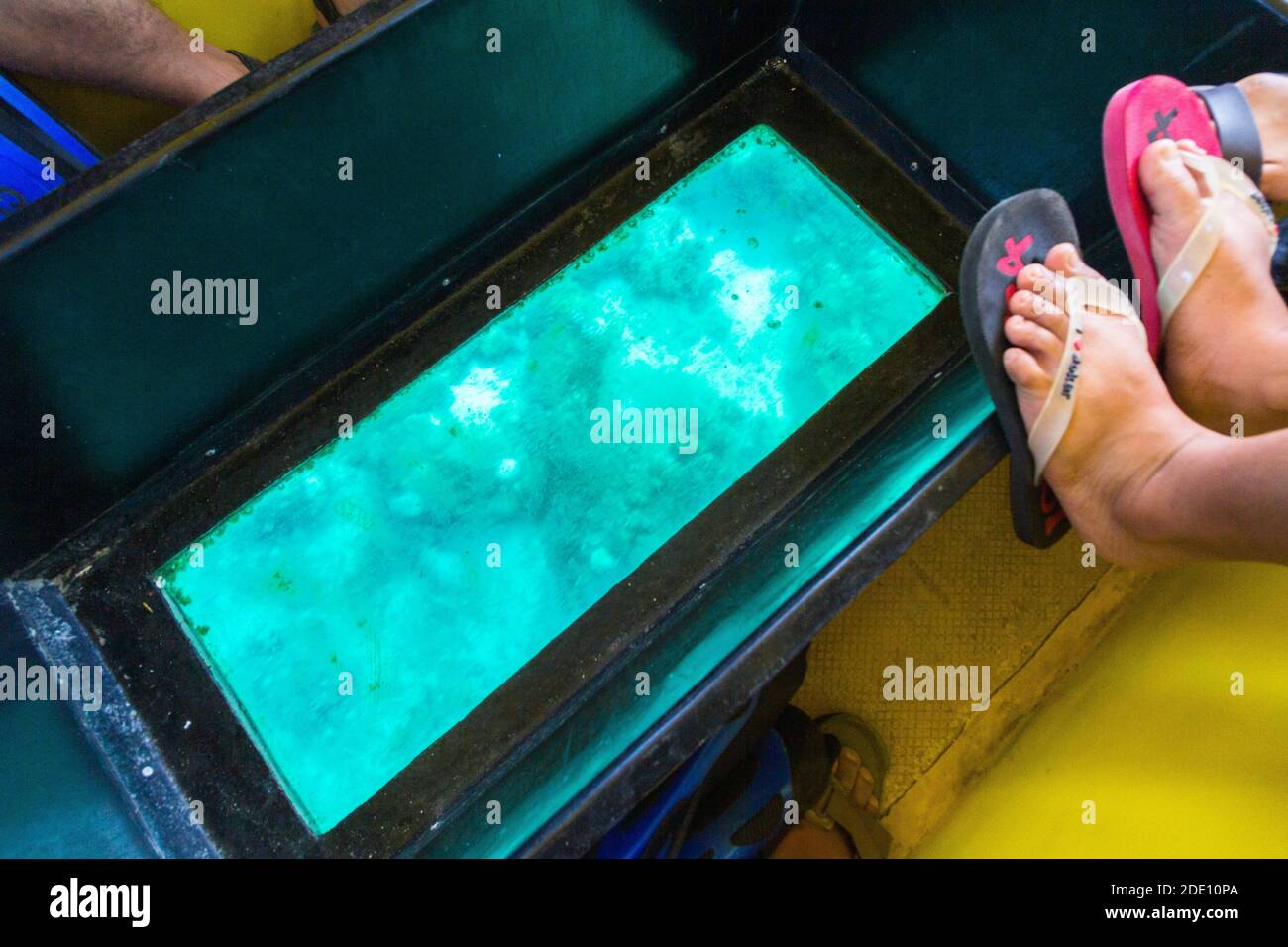 A tourist riding a glass bottomed boat off Gili Trawangan in Lombok ...