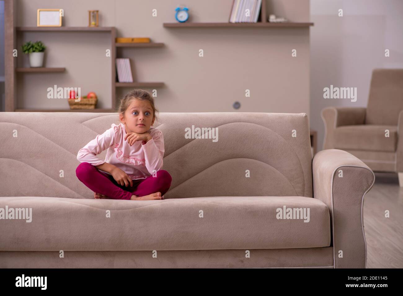 Little girl staying alone at home Stock Photo - Alamy