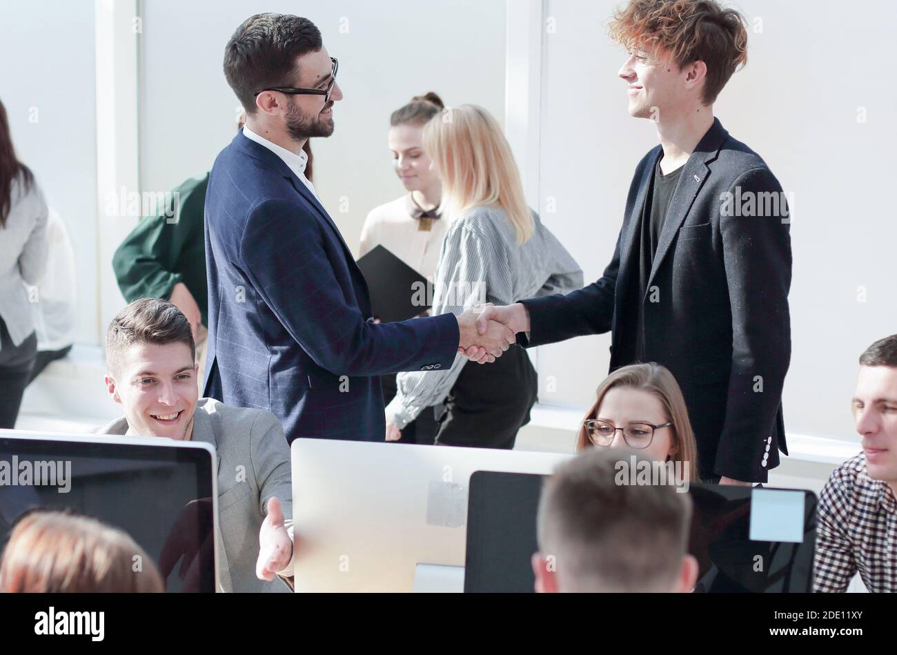 employees discussing work issues in the office Stock Photo - Alamy