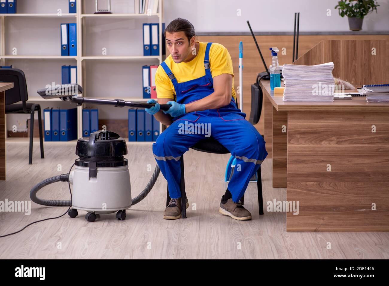 Male contractor cleaning the office Stock Photo - Alamy