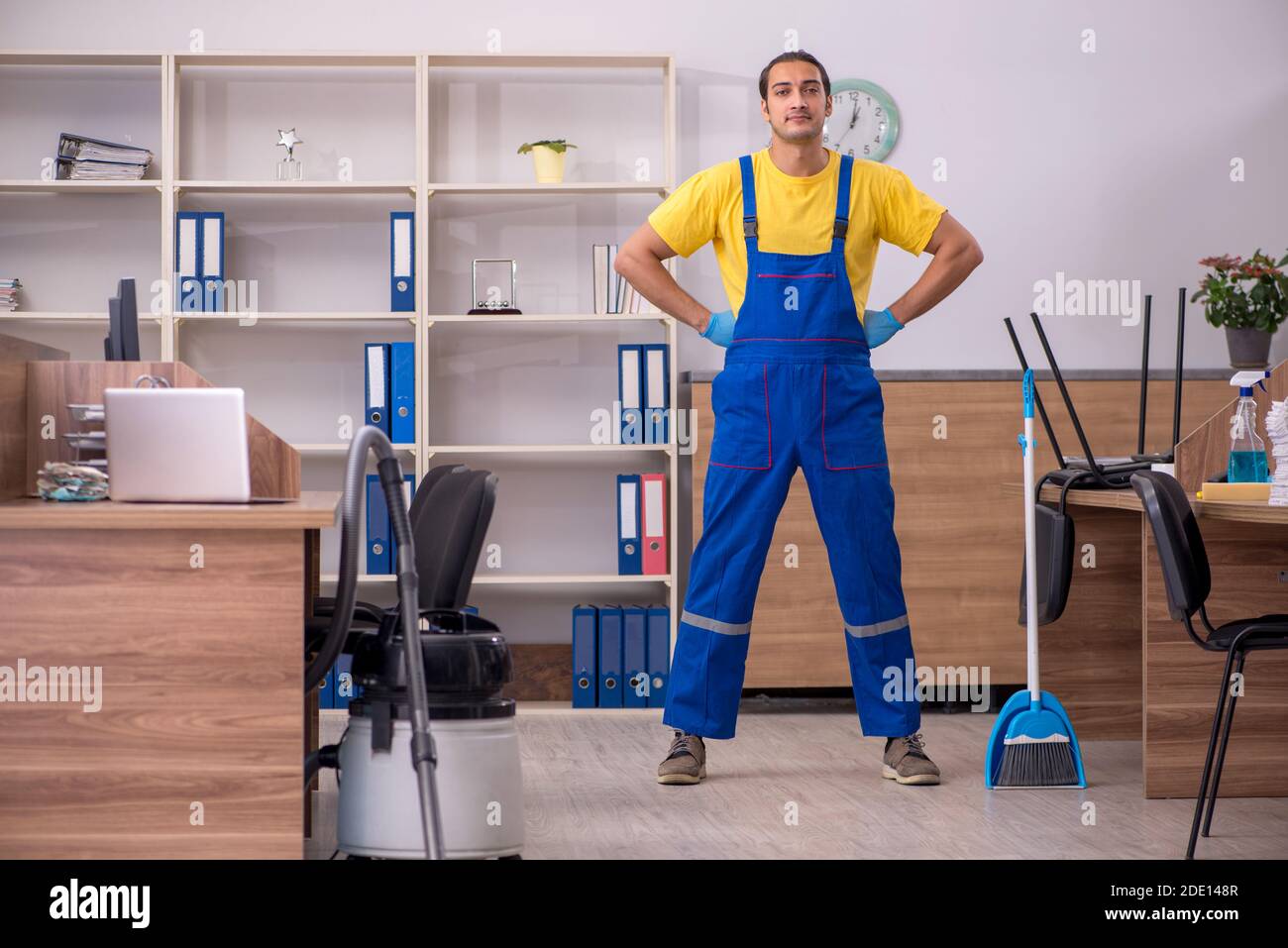 Male contractor cleaning the office Stock Photo - Alamy