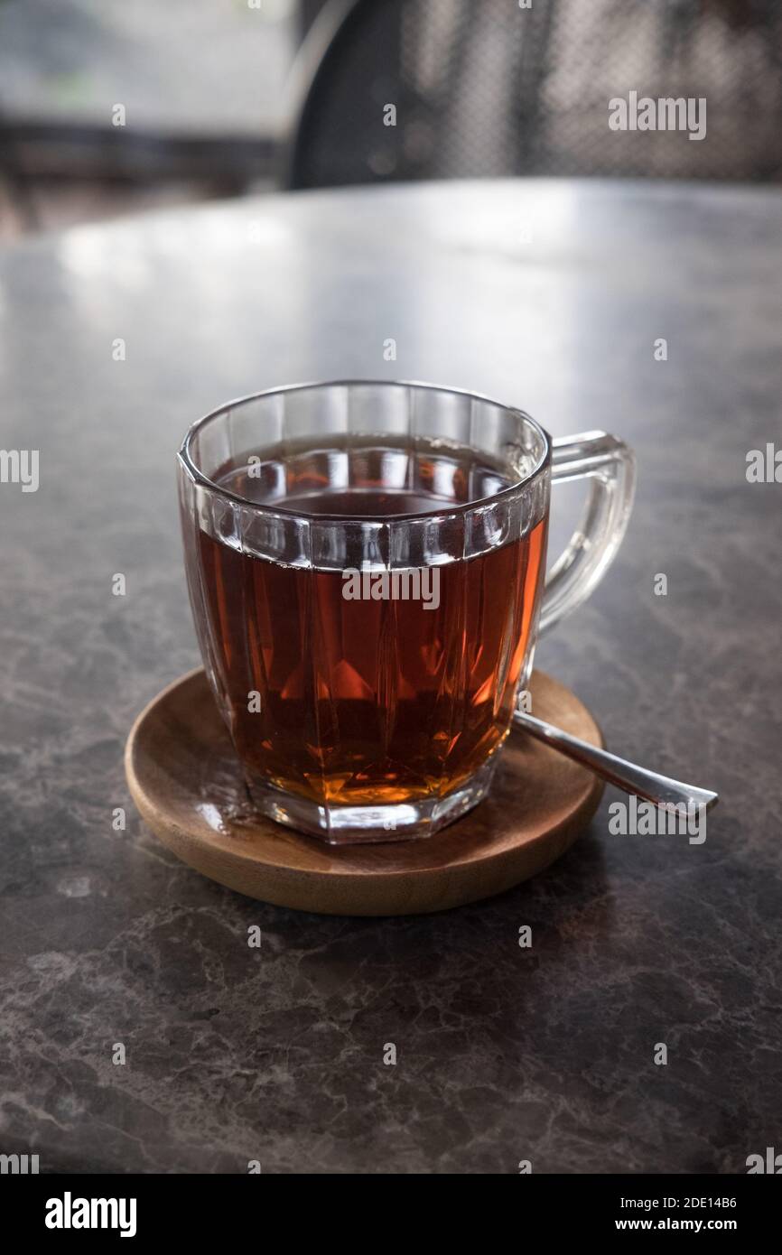 A closeup shot of a cup of hot black tea on a blurred background Stock ...