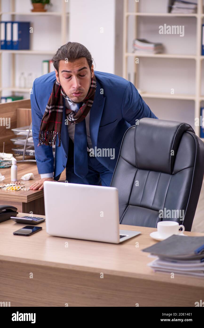 Sick businessman employee suffering at workplace Stock Photo - Alamy