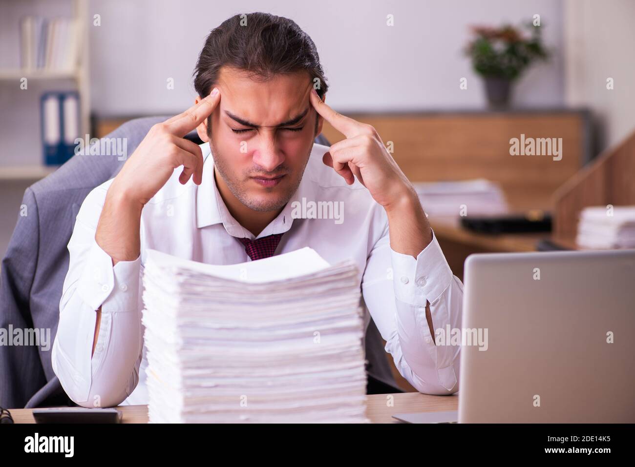 Young employee extremely tired with excessive work Stock Photo - Alamy