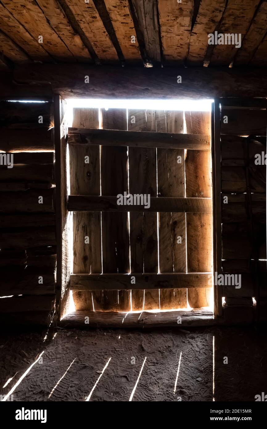 Door in barn with light streaming through cracks at Caroline Lockhart ...