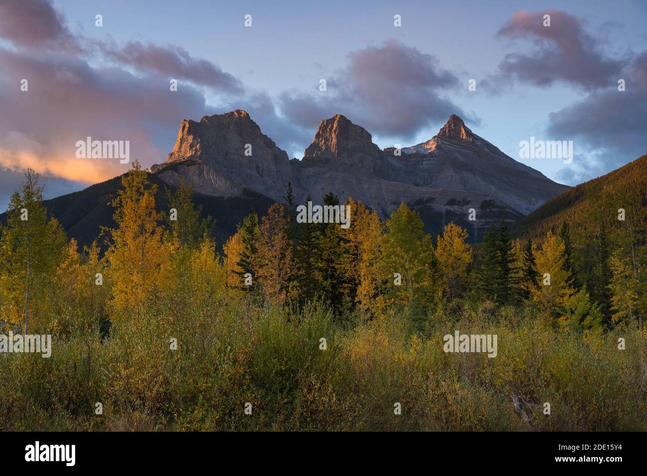 Sunrise in autumn at Three Sisters Peaks near Banff National Park, Canmore, Alberta, Canadian ...