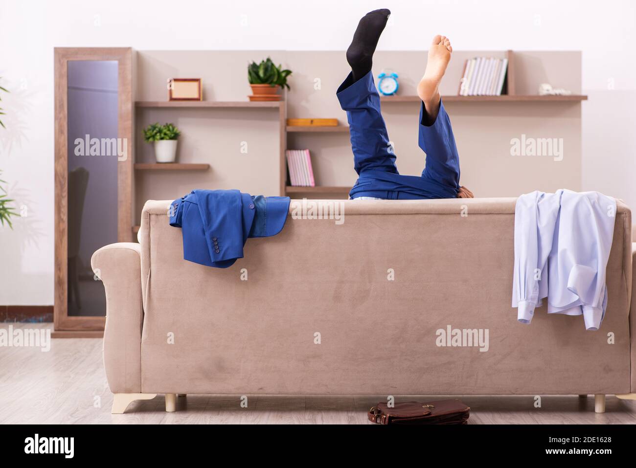 Young employee getting up late at home Stock Photo - Alamy