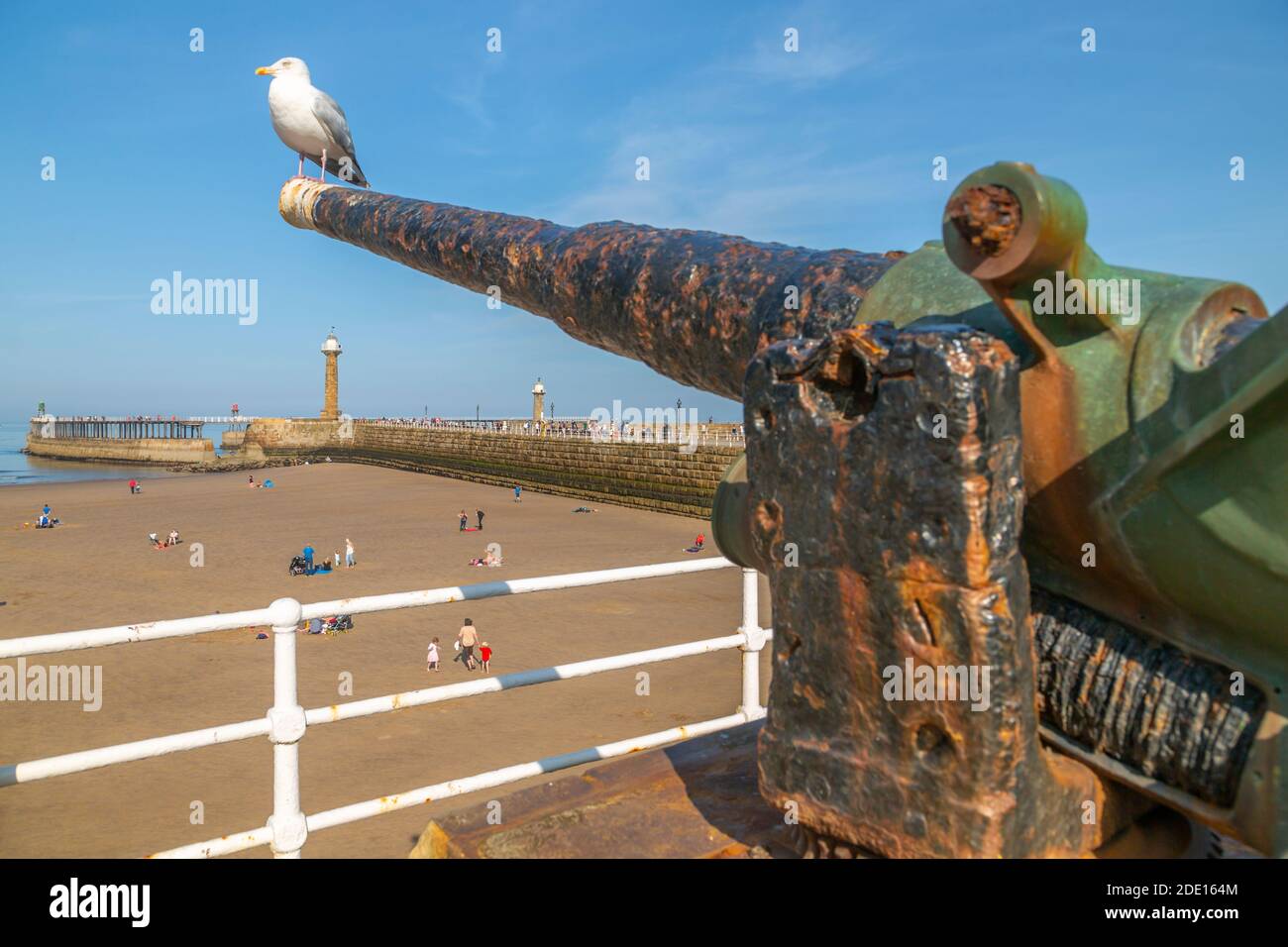 View of cannon overlooking Whitby West Pier and lighhouse, Whitby ...