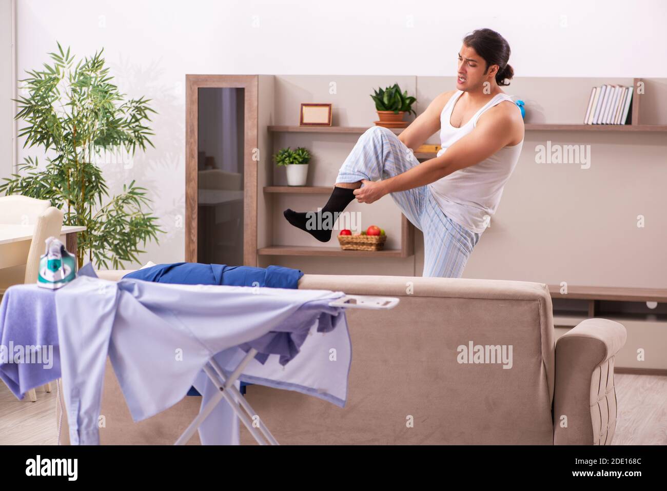 Young employee getting up late at home Stock Photo - Alamy