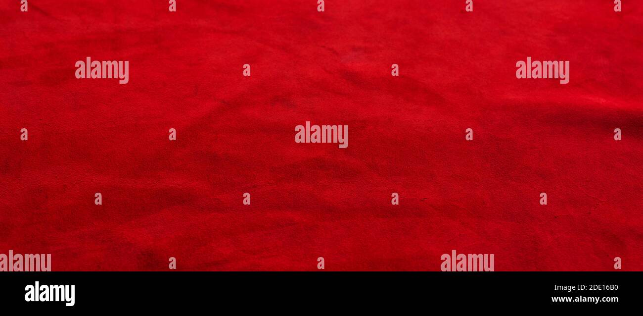 Red matte background of suede fabric, closeup. Velvet texture of ...