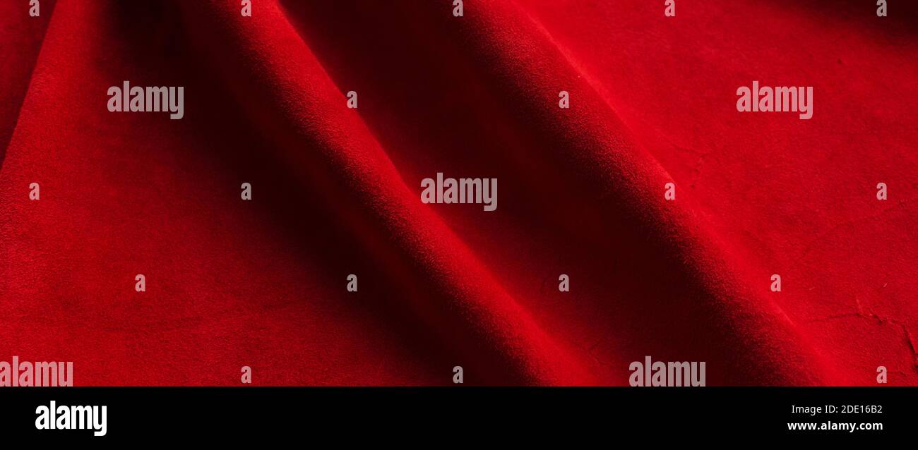 Red matte background of suede fabric, closeup. Velvet texture of ...