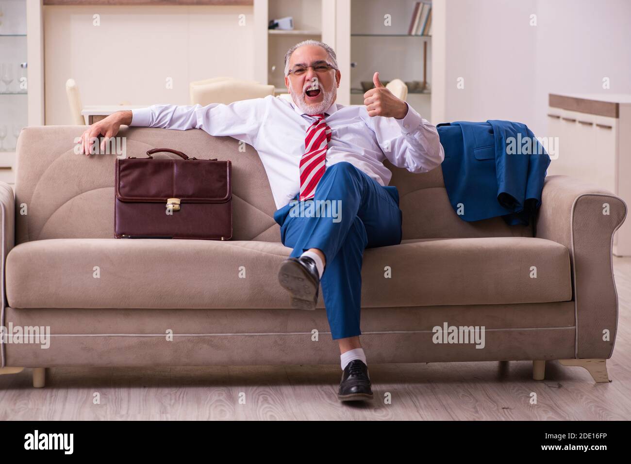 Senior male boss employee coming home from work Stock Photo - Alamy